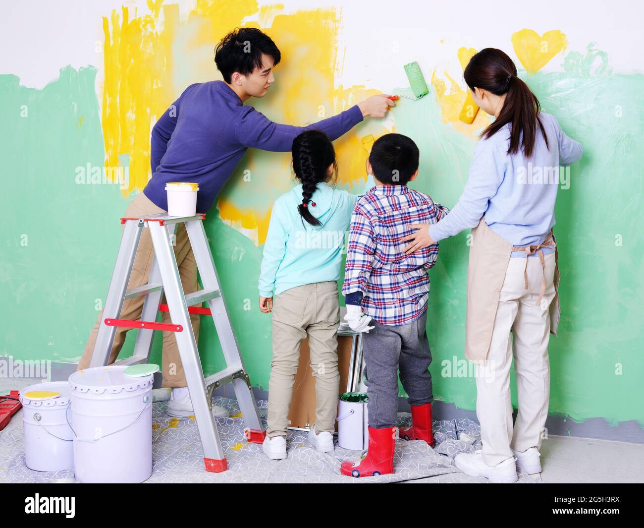 A happy family of four painting walls high quality photo Stock Photo ...