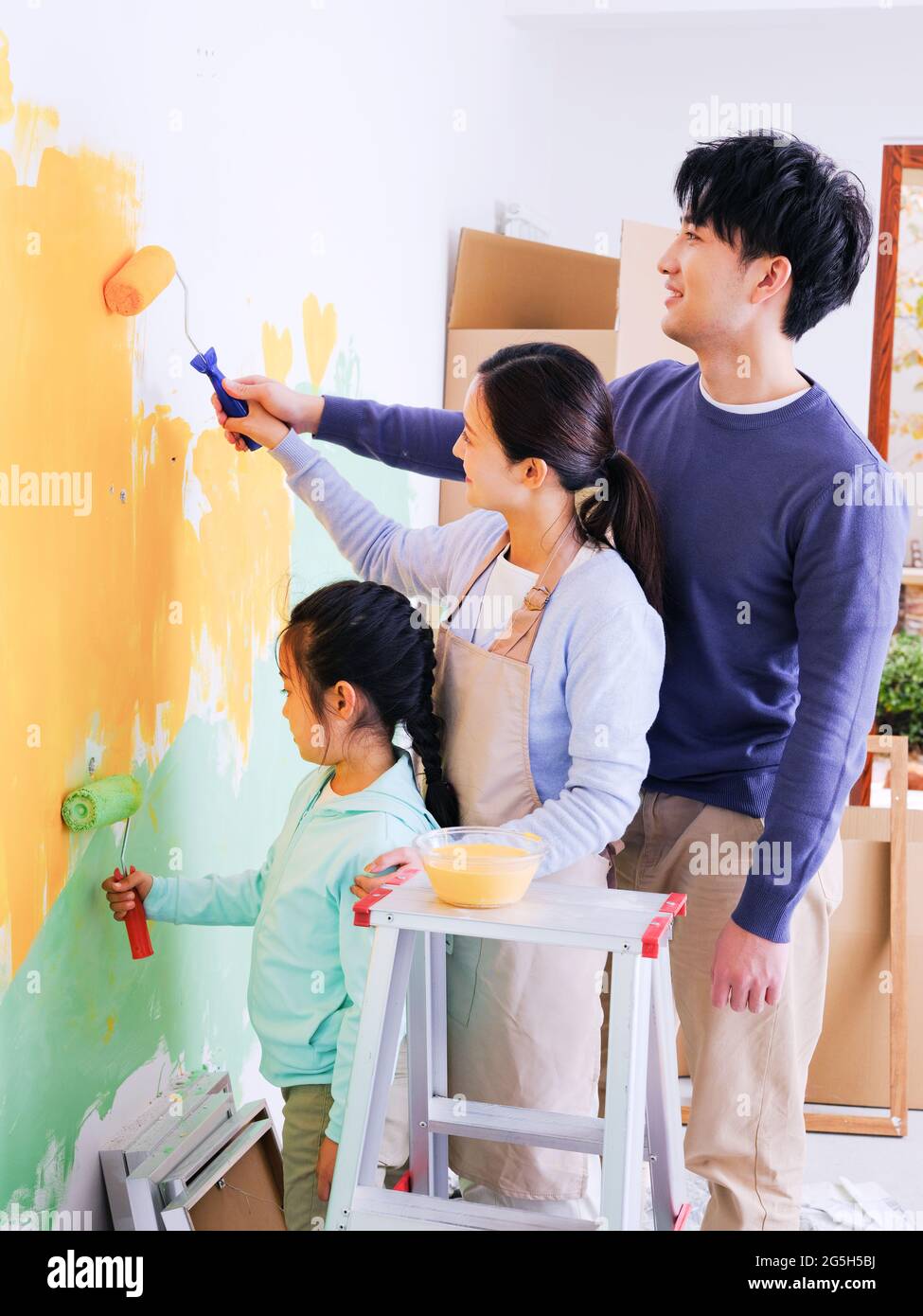 A happy family of three painting walls high quality photo Stock Photo ...