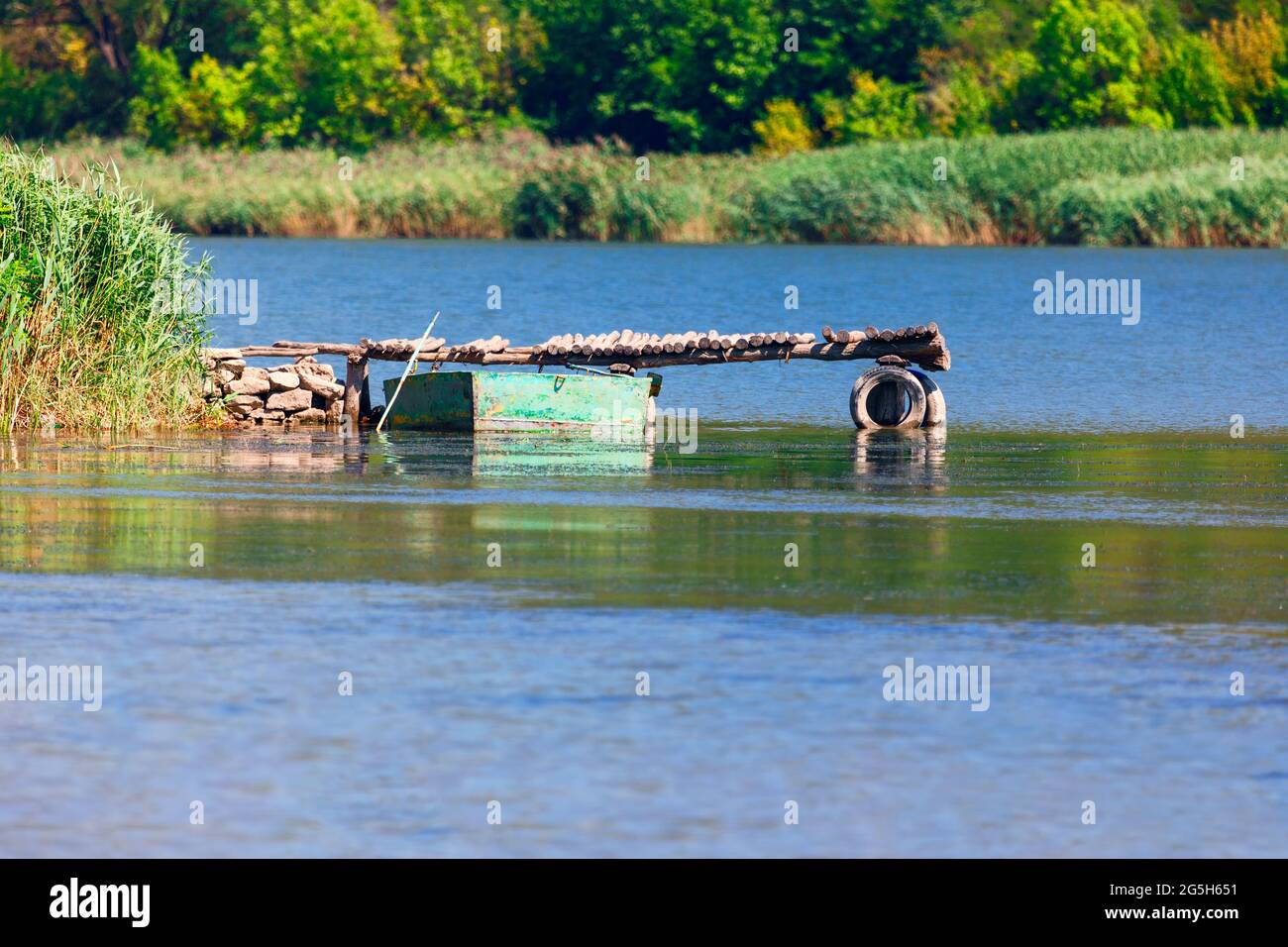 Rustic harbor made by wooden logs . Fishing in the village . Wooden ...