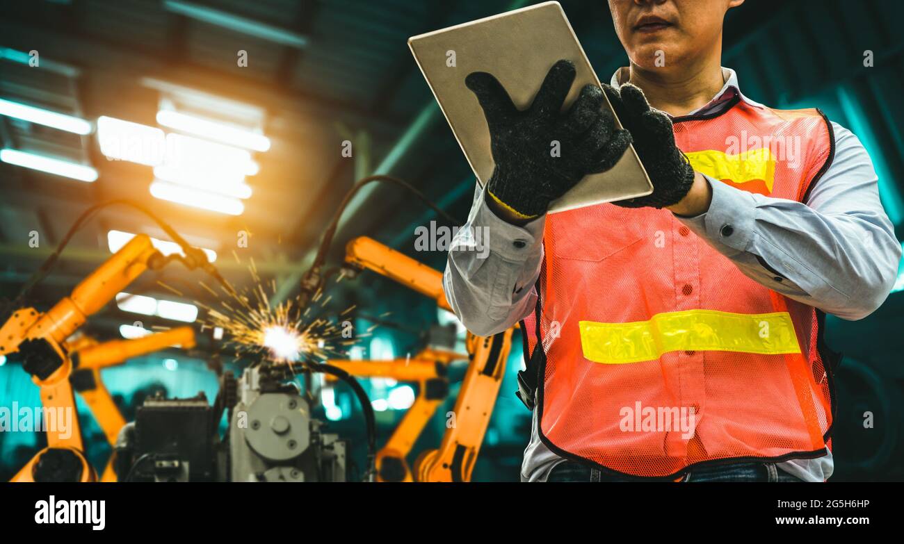 Engineer use advanced robotic software to control industry robot arm in ...