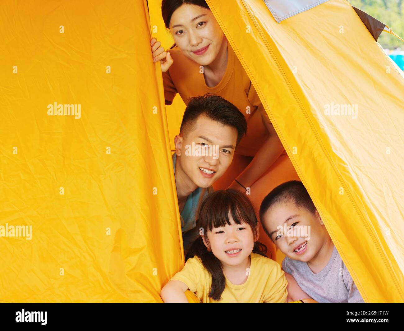 Happy family of four in tent high quality photo Stock Photo - Alamy