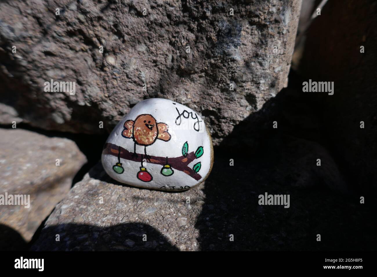 Joy word and happy cartoon bird painted on kindness rock Stock Photo ...