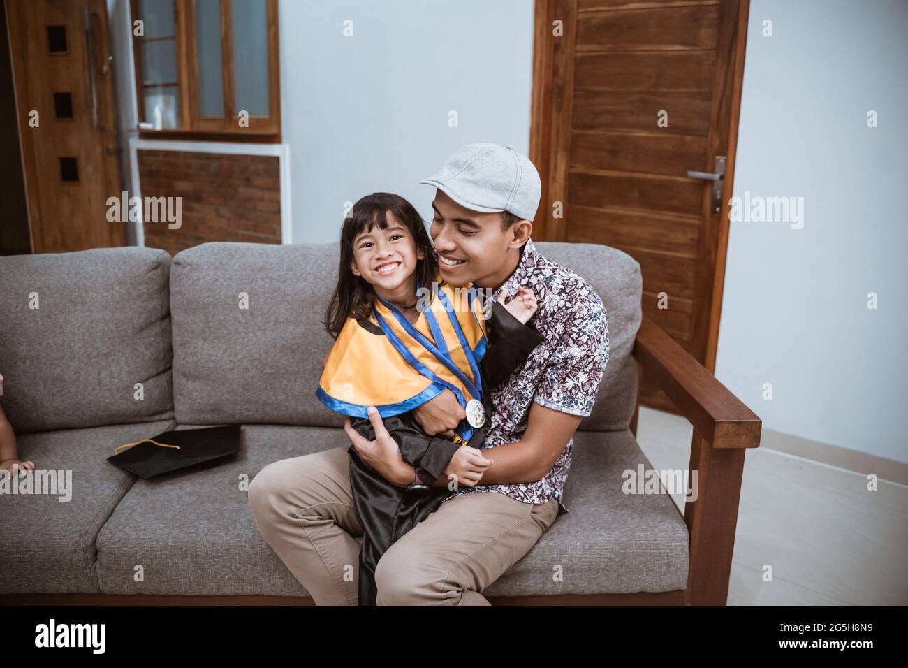Kindergarten graduation. asian father embrace his daughter Stock Photo ...
