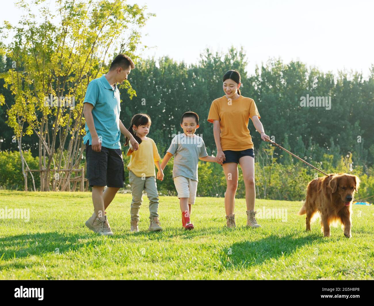 Family walking dog suburb hi-res stock photography and images - Alamy