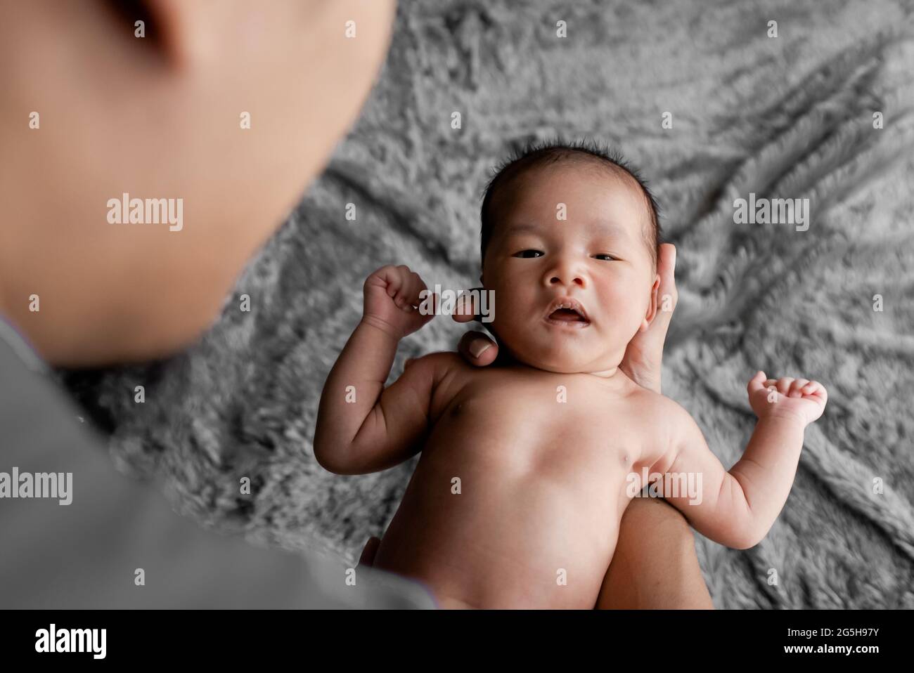 cute newborn baby carried by her mother's hand Stock Photo - Alamy