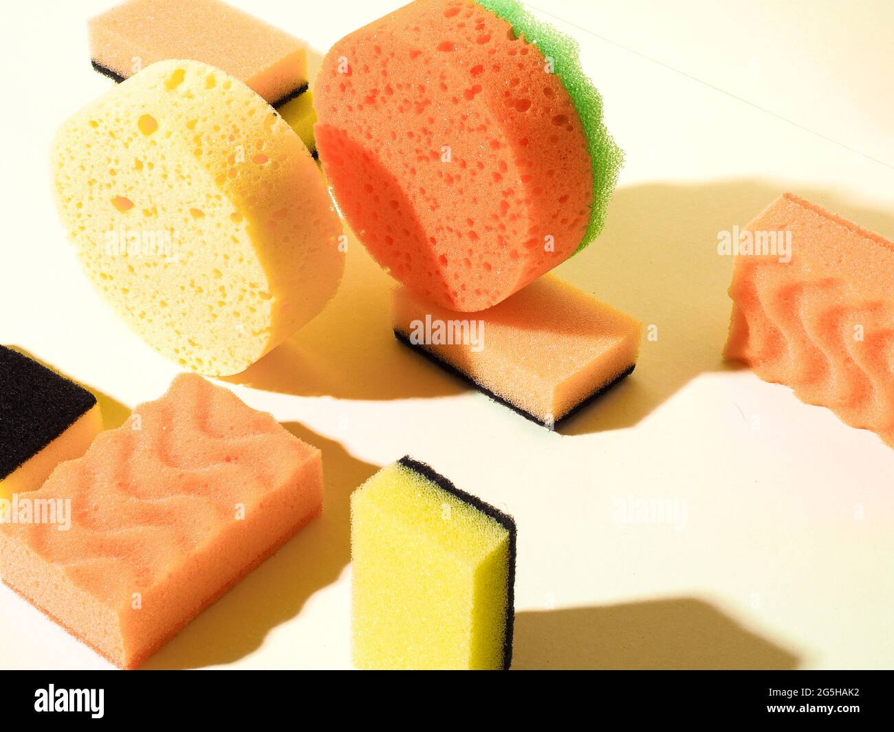 Foam rubber sponges in different shapes. Close up view. Yellow ...