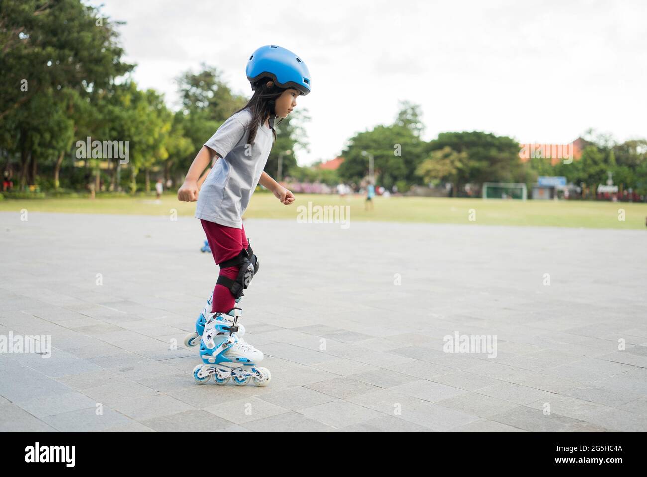 asian girl going on her in-line skates Stock Photo - Alamy