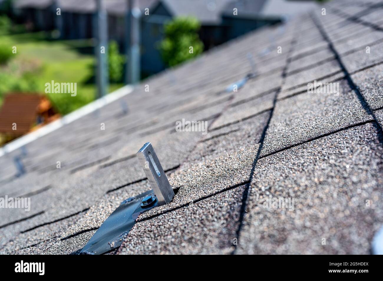 Residential asphalt shingle roof with metal anchors installed for the ...