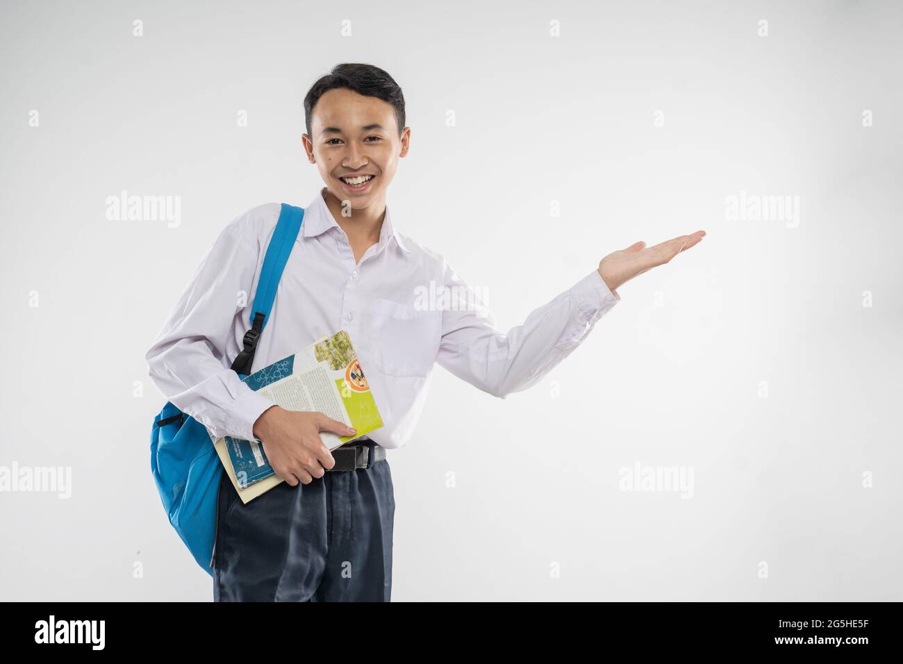 a boy in junior high school uniform offering something with a hands ...