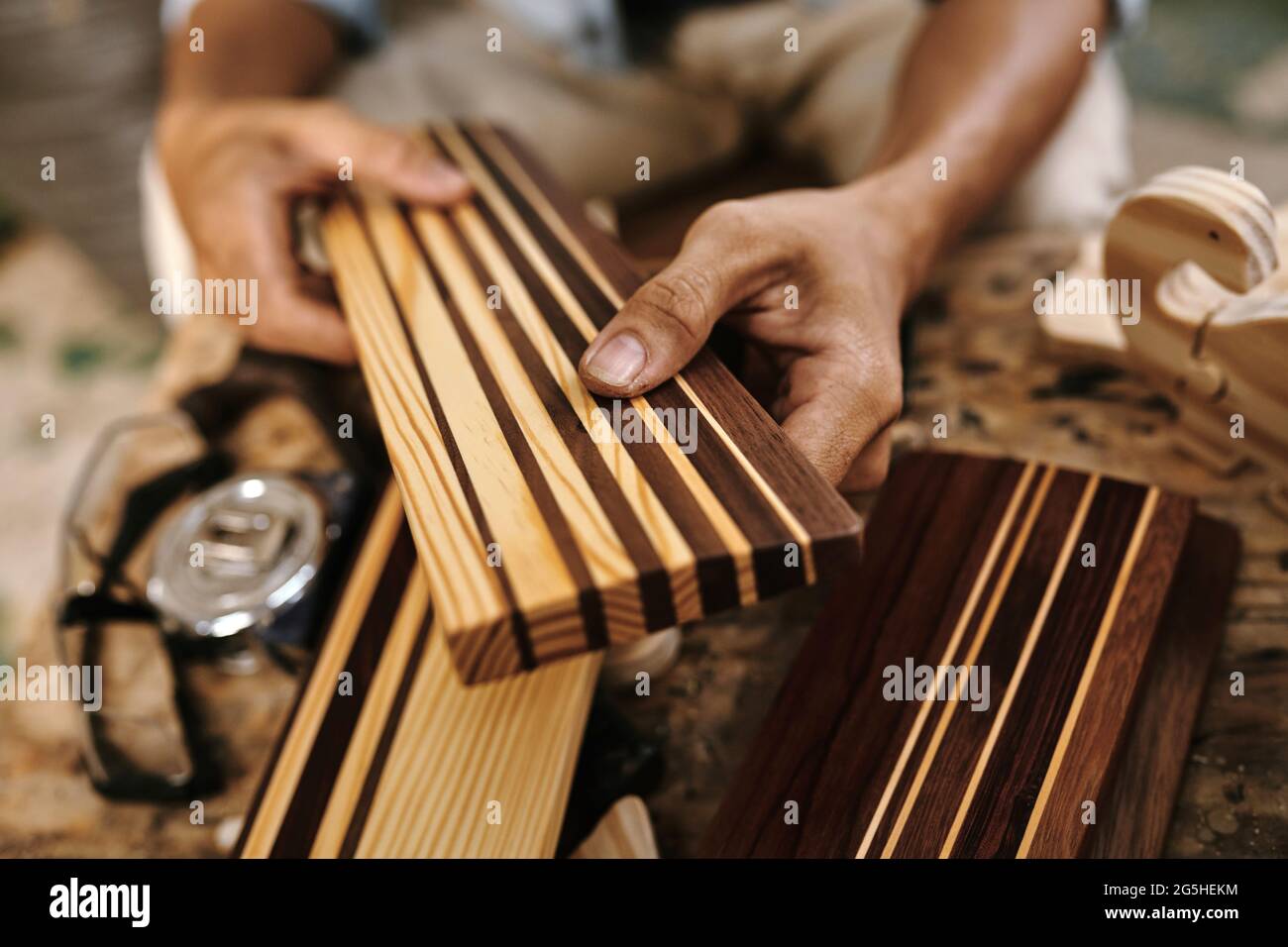 Carpenter showing pieces of walnut and maple wood that have been fused ...