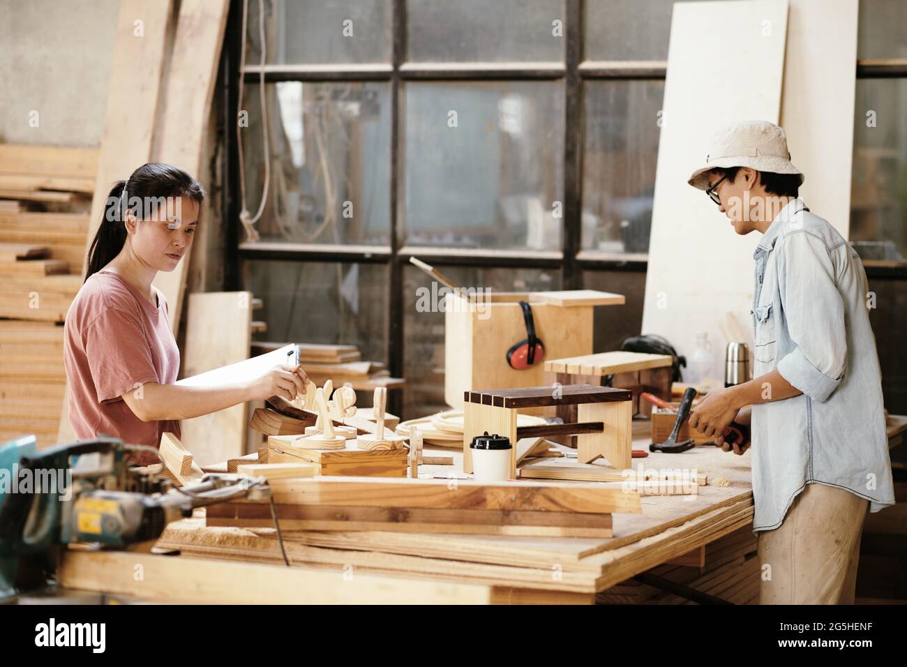 Team of young carpenters creating various woodwork projects at ...