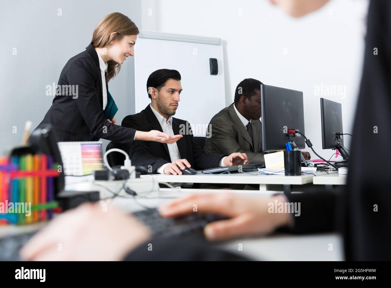 Man helping colleague computer hi-res stock photography and images - Alamy
