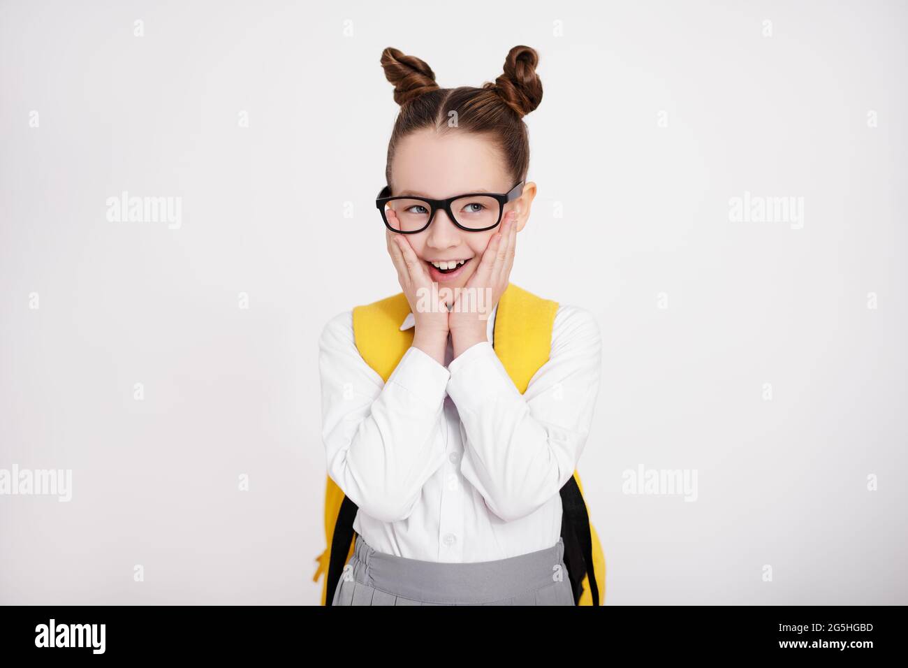 portrait of cute surprised girl in school uniform and eyeglasses over ...