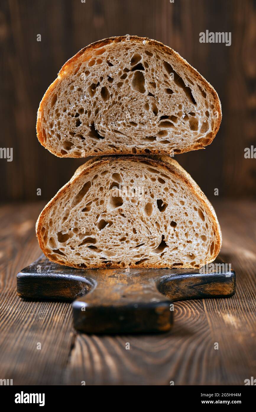 Loaf of artisan sourdough bread with porous texture cut on half Stock ...