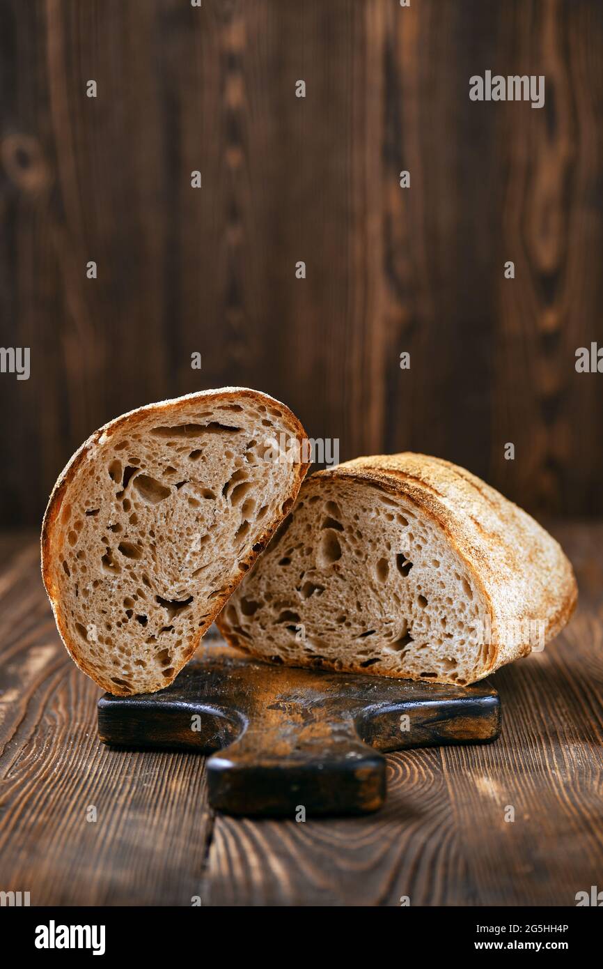 Loaf of artisan sourdough bread with porous texture cut on half Stock ...