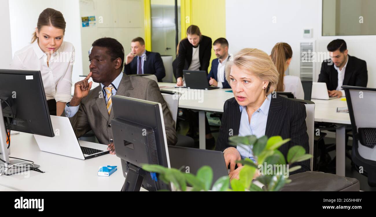 Business people working in open plan office Stock Photo - Alamy