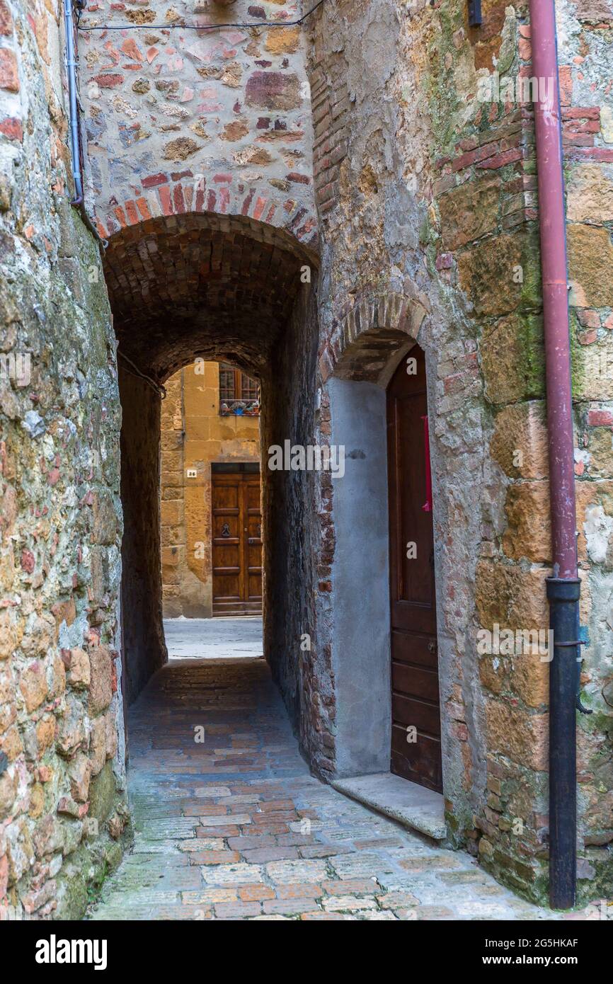 Narrow dark alley to the street in an old Italian village Stock Photo ...