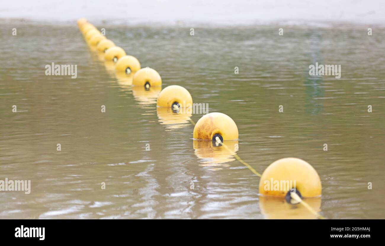 Nature pool with buoys diagonal line - Yellow buoys Stock Photo - Alamy