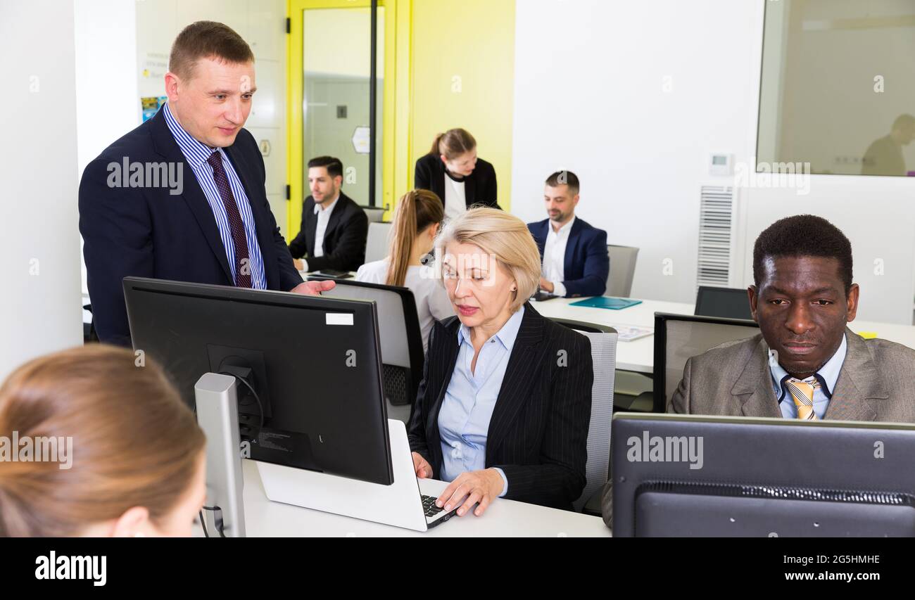 Business people working in open plan office Stock Photo - Alamy