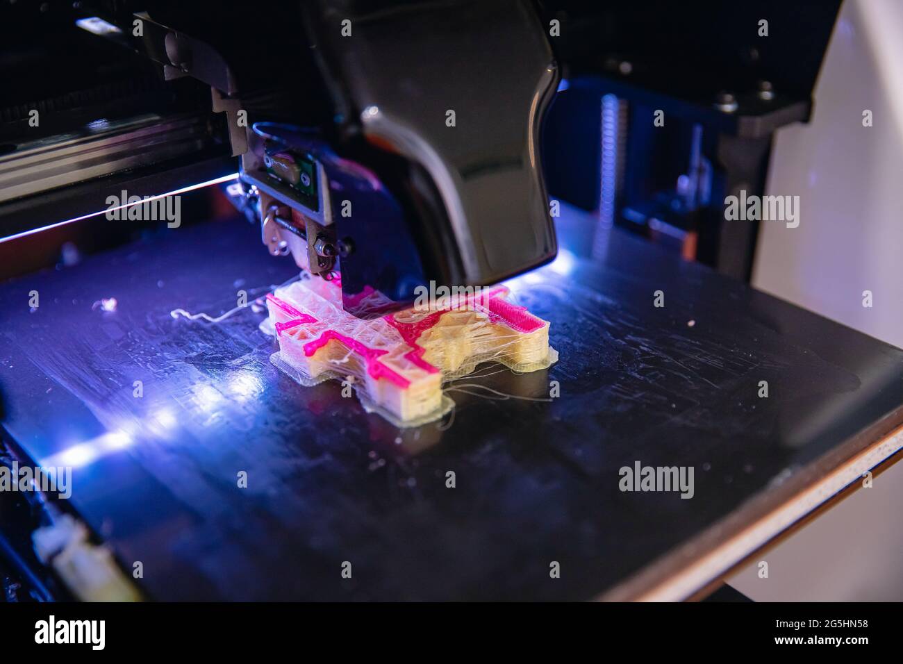 Macro photo Robot Modern 3D plastic printer printing figure Stock Photo ...