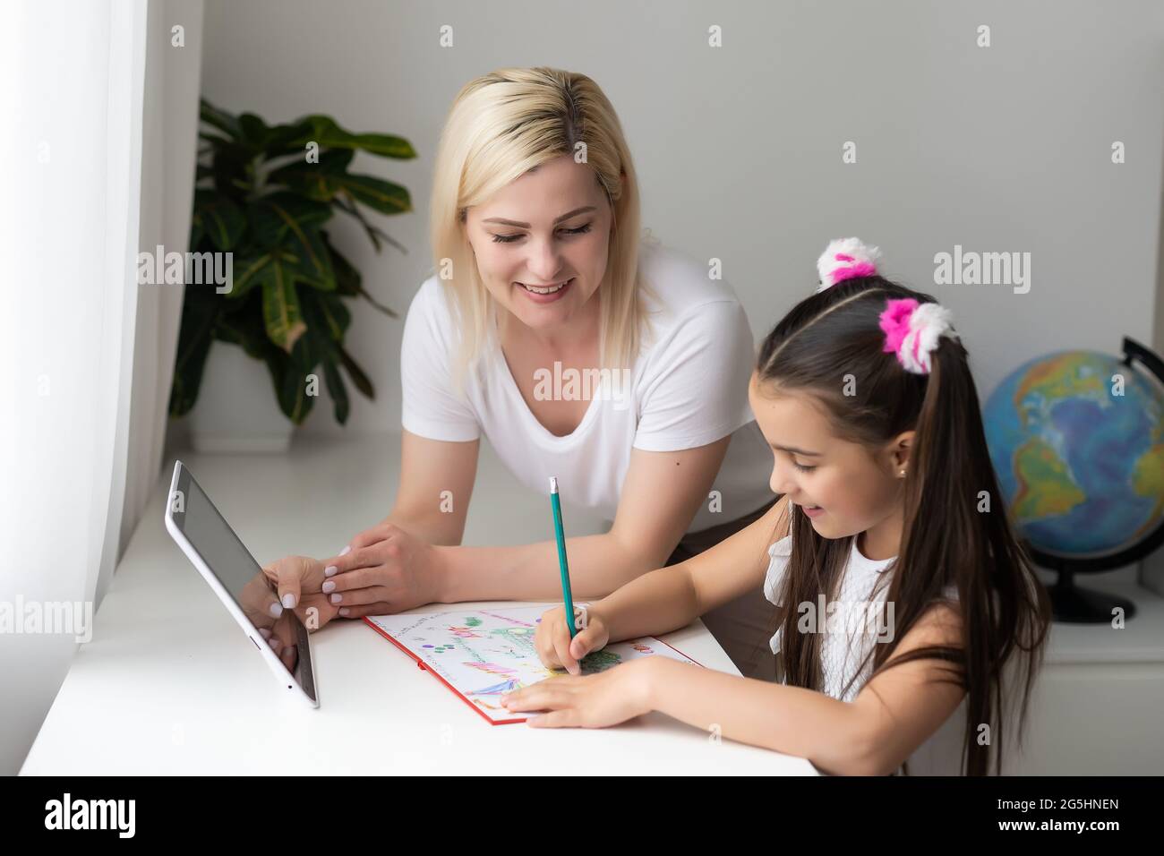 Online education of children. Mother and daughter of preschool watching ...