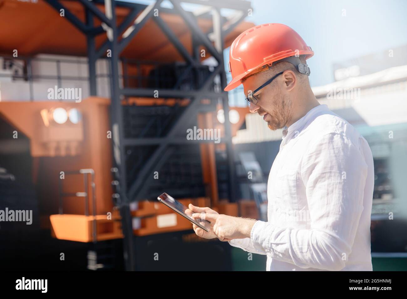 Coal mine worker in open pit use tablet computer for control quality work and ecology Stock ...