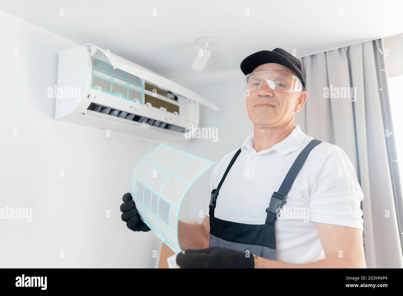 Worker man instal ac conditioner from home or office, maintenance of ...