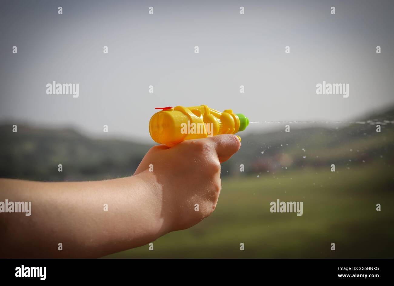 Squirting water gun hi-res stock photography and images - Alamy
