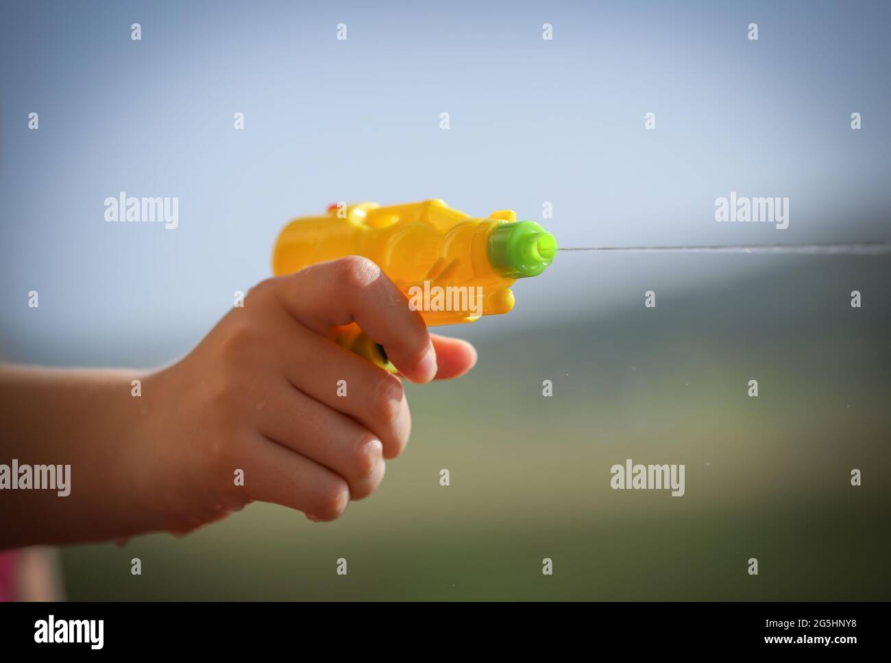 Child hand water gun hi-res stock photography and images - Alamy
