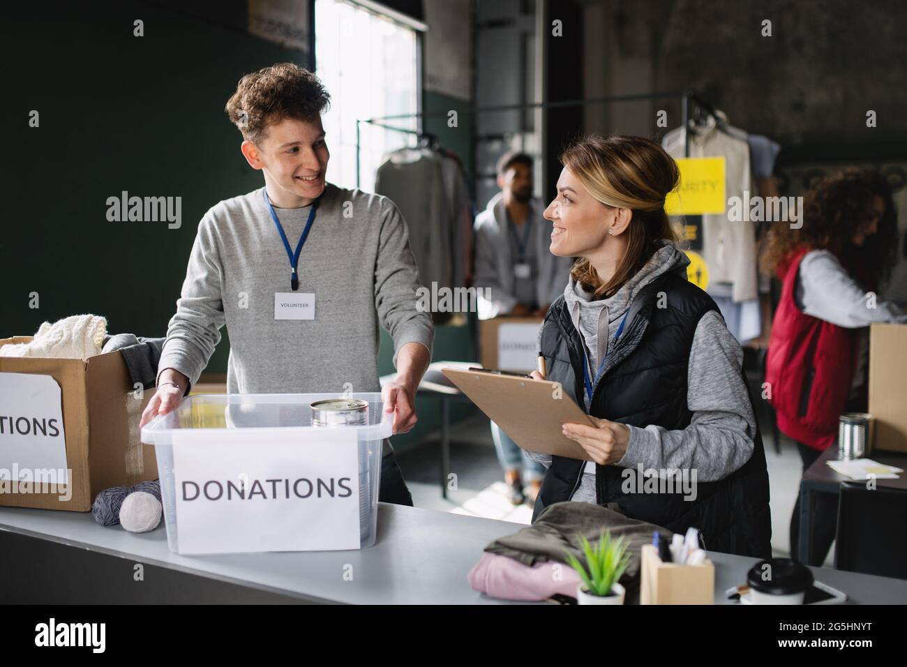 Group of volunteers working in community charity donation center ...
