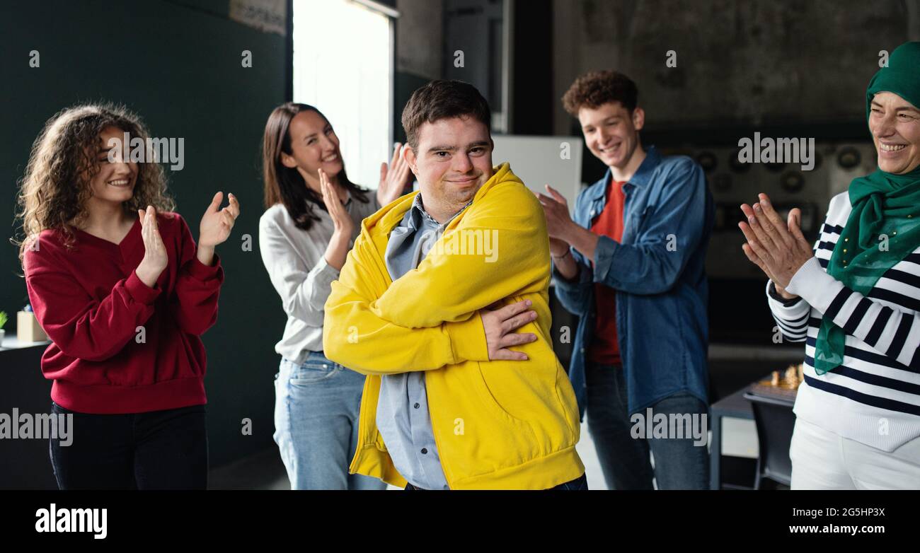 Down syndrome man with friends in community center, inclusivity and ...