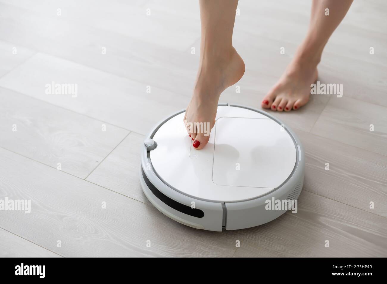 Human leg using smart robotic technology vacuum cleaner cleaning floor ...