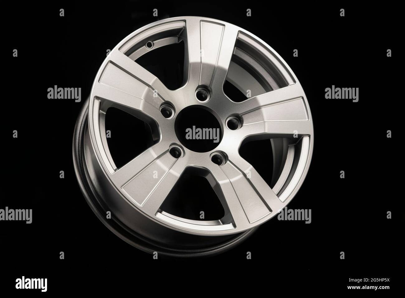 new silver alloy wheels for SUVs on black background, side view Stock ...