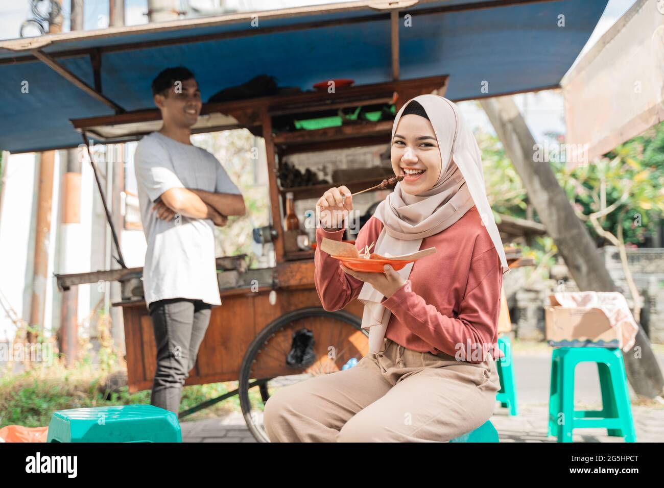 beautiful customer ordering food from street seller Stock Photo - Alamy