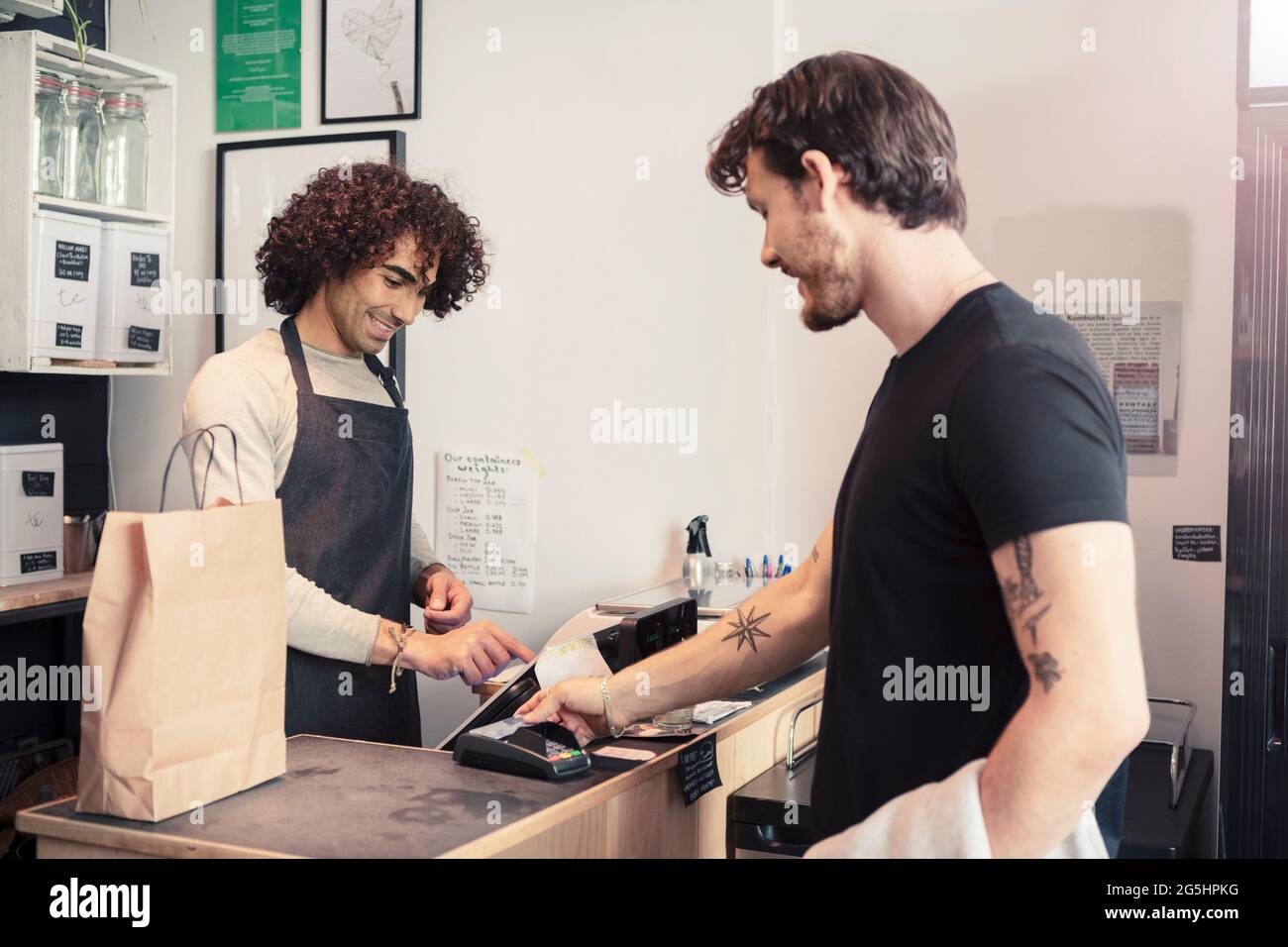 Cashier paper bag hi-res stock photography and images - Alamy