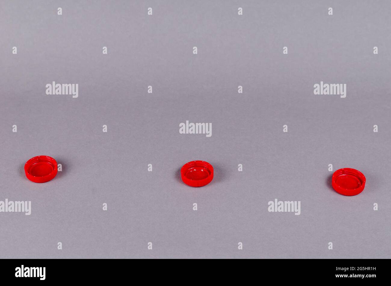 Red bottle stoppers gainsboro background. Minimalist composition with ...