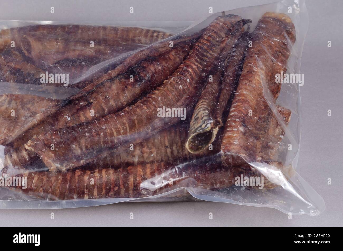 Air dried dog treats on a gray background. Dental treats in transparent ...