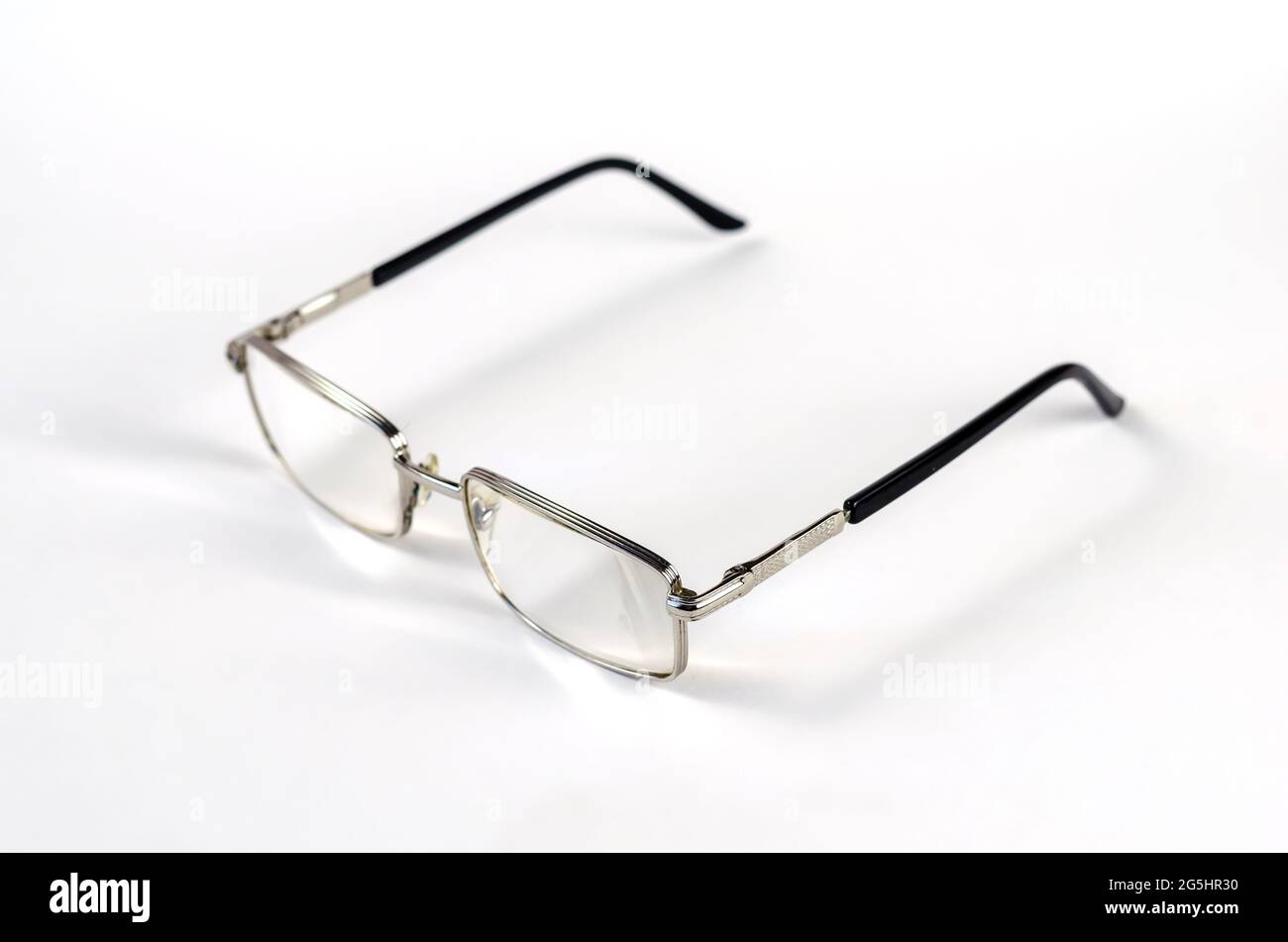 Reading glasses on a white background. Metal-rimmed glasses with ...