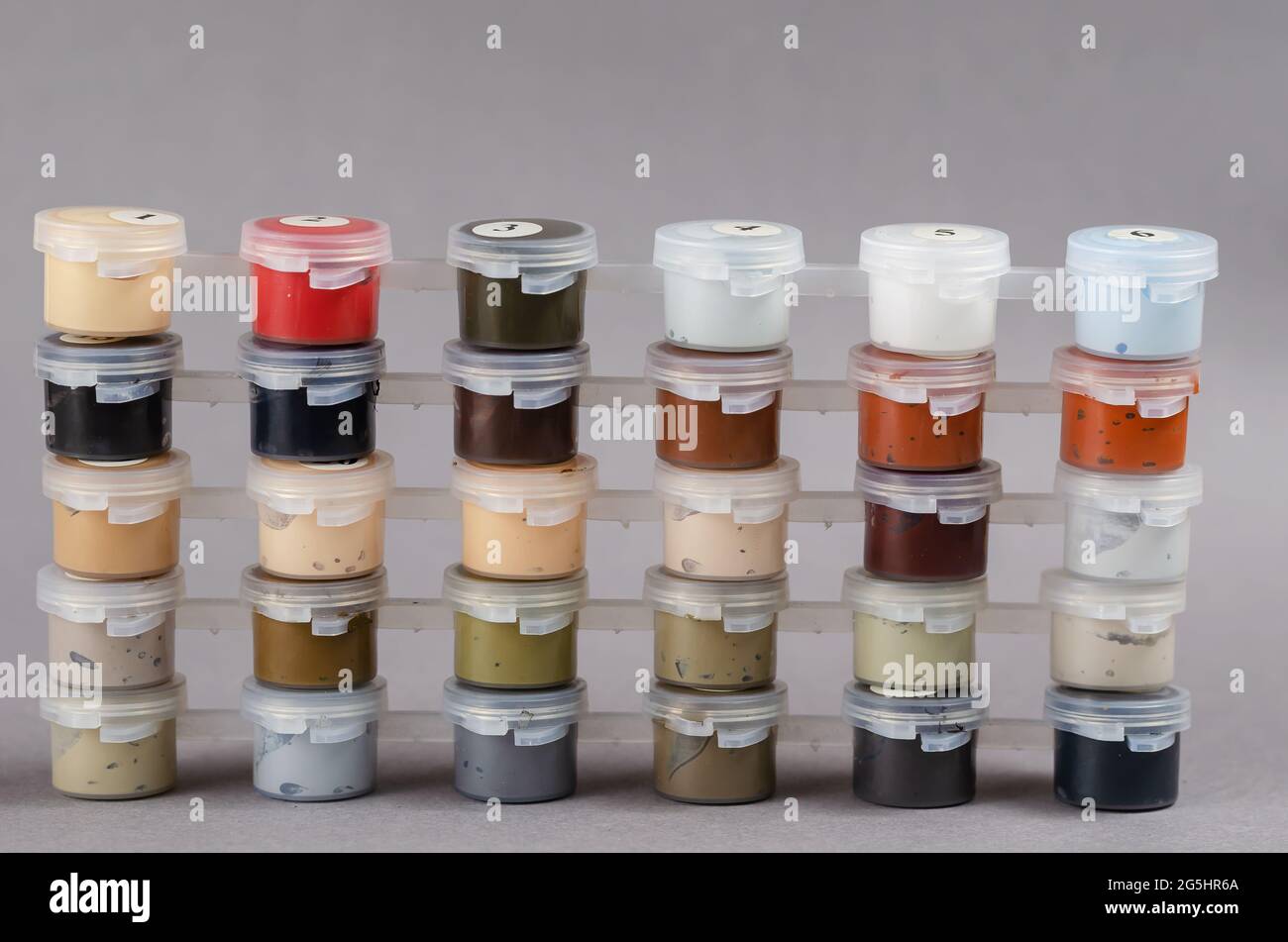 Set of acrylic paints for painting, background. Plastic containers with ...