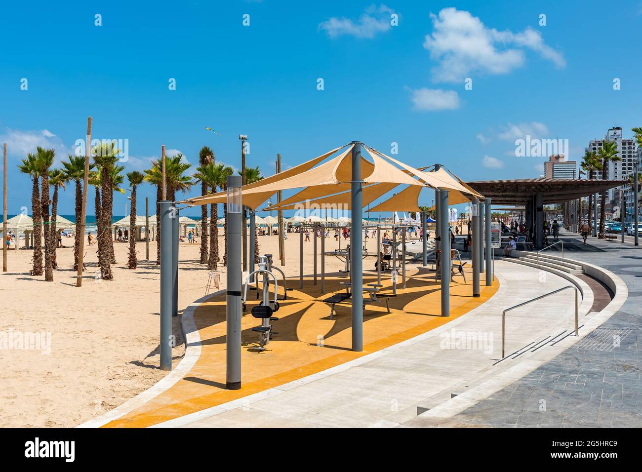 Promenade along public beach with open air gym on the sand in Tel Aviv ...