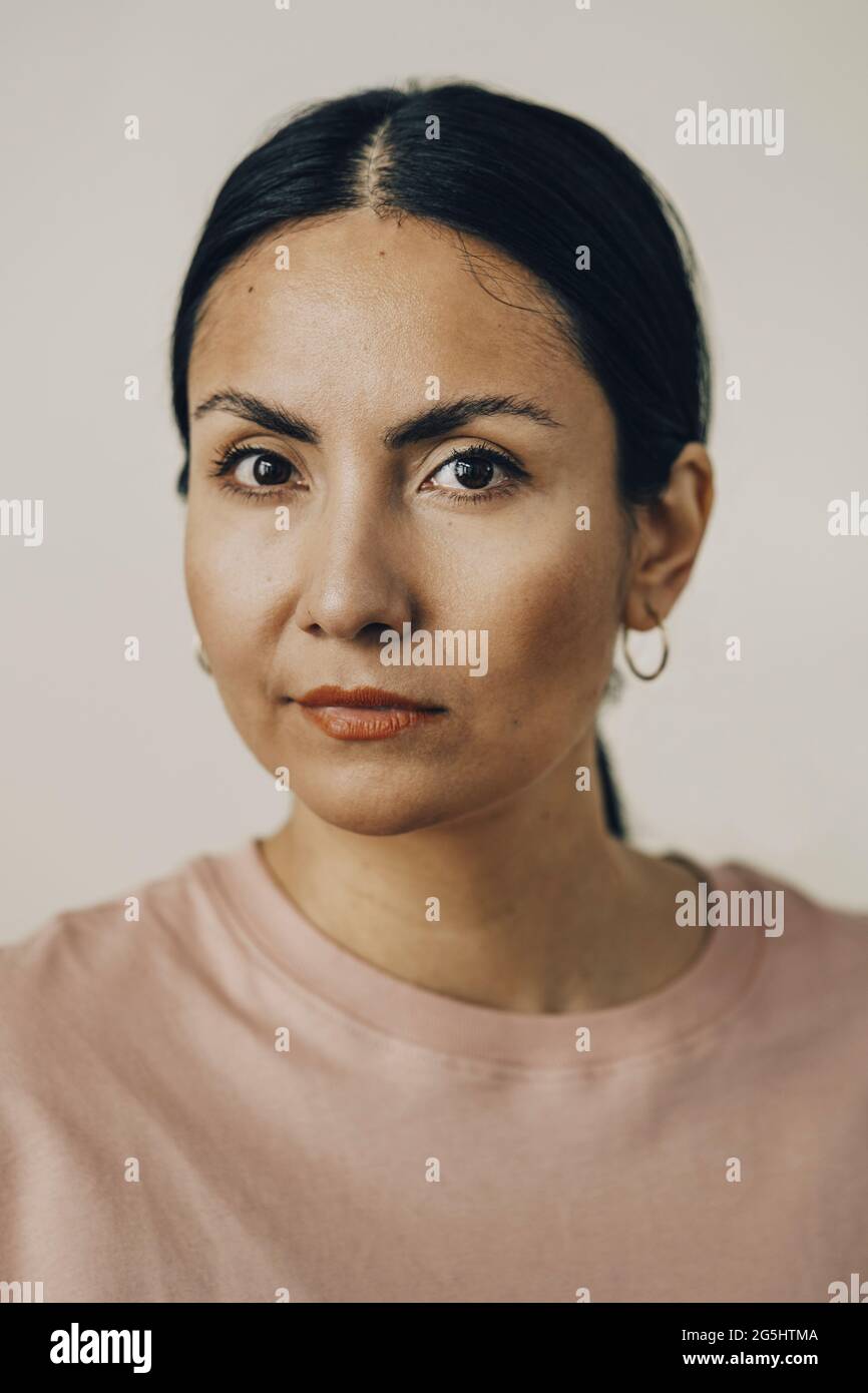 Portrait of mid adult woman against white background Stock Photo - Alamy