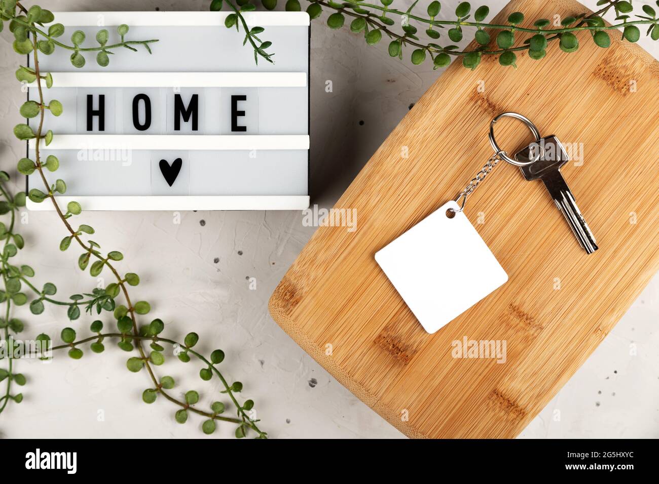 Blank rhombus white sublimation keychain mockup next to board with home ...