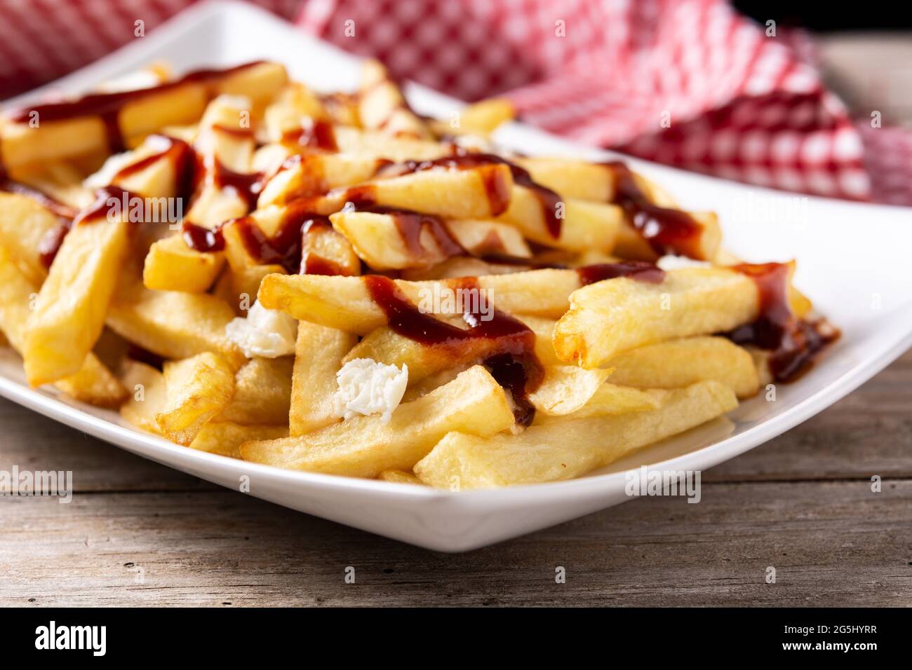 Traditional Canadian Poutine on wooden table Stock Photo - Alamy