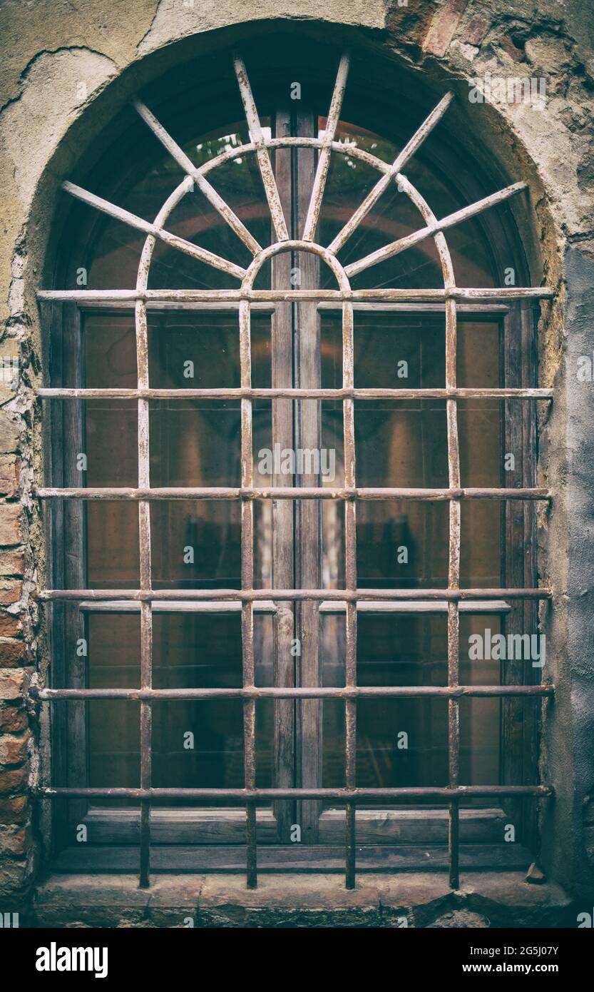 Ancient medieval window with wrought iron bars Stock Photo - Alamy