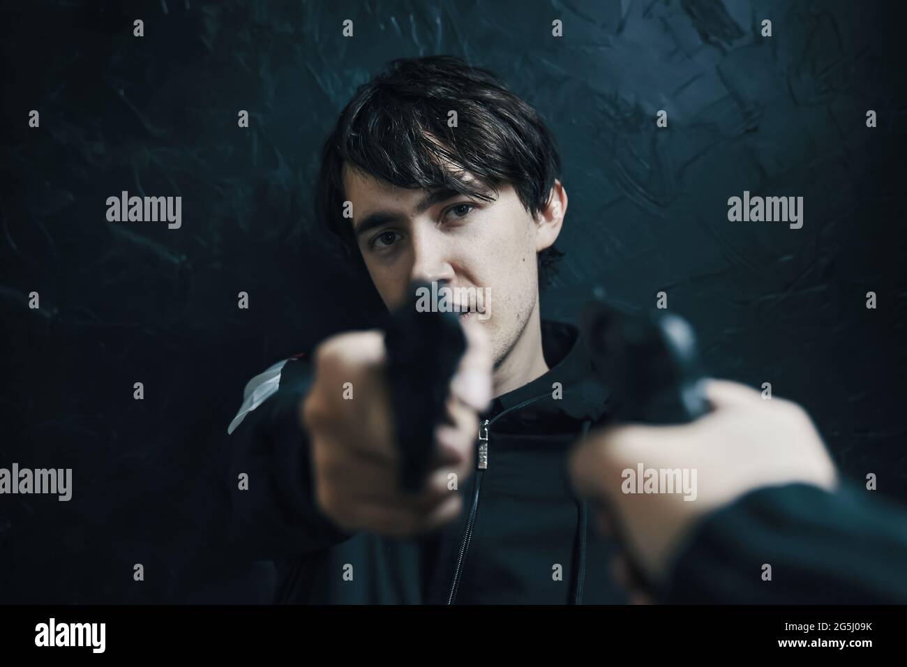 First-person view of hand with gun pointed at guy with pistol. Two ...