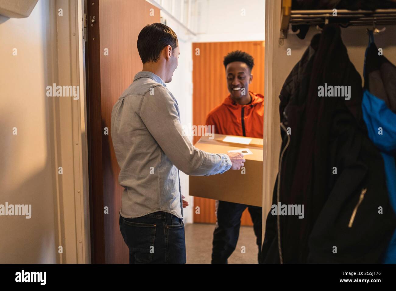 Person with package hi-res stock photography and images - Alamy