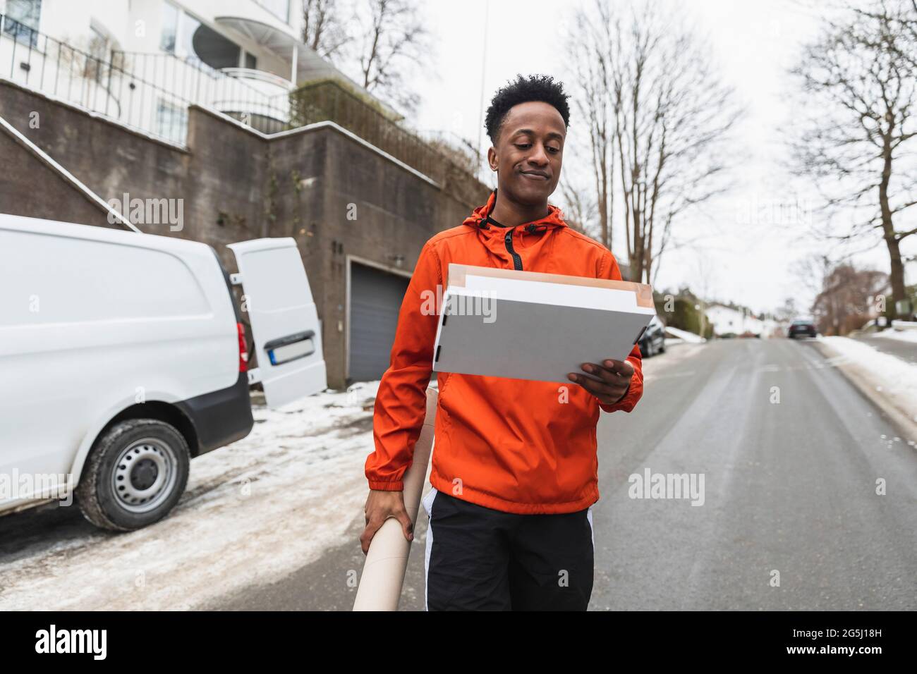 African american delivery man carrying hi-res stock photography and ...