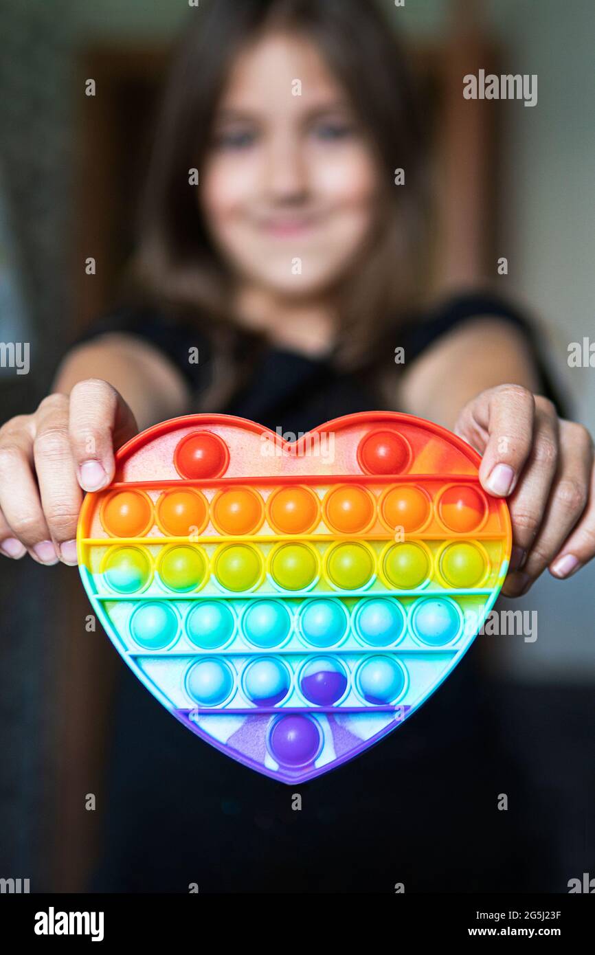 Portrait girl with modern popit toy. Colorful and bright pop it toy ...