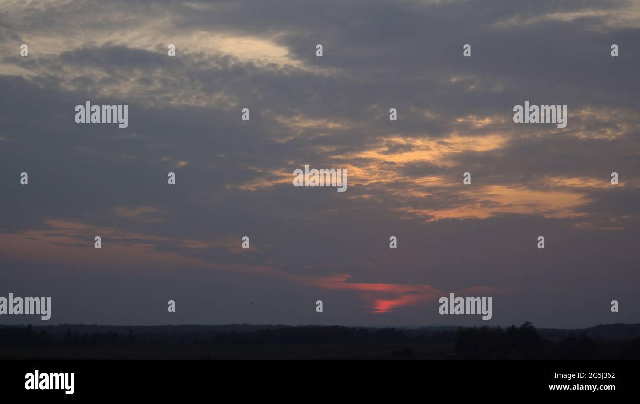 Evening the colorful cloudy sky at the sunset time. The picturesque ...