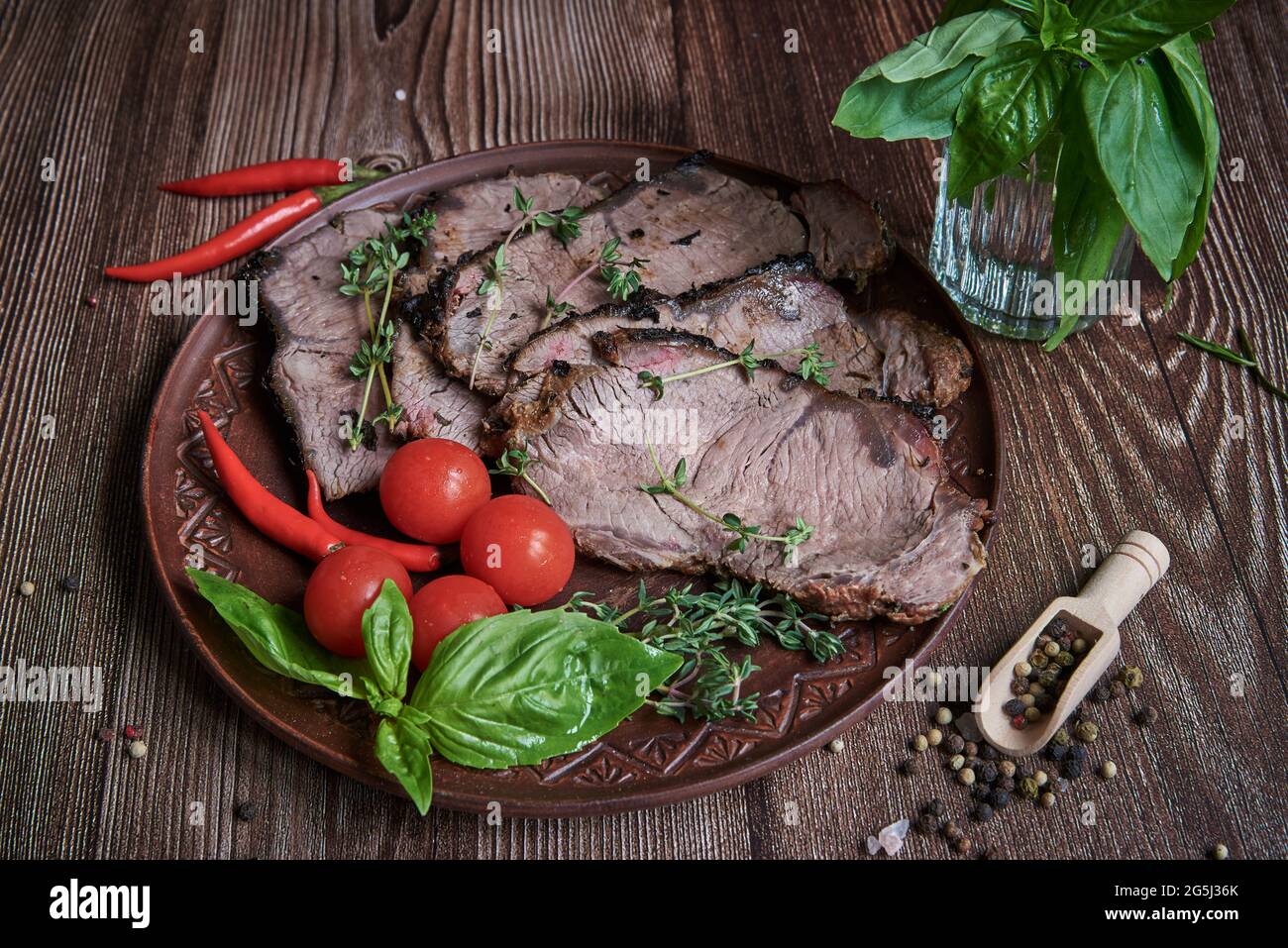 Sliced pieces of fried meat on a clay plate Stock Photo - Alamy
